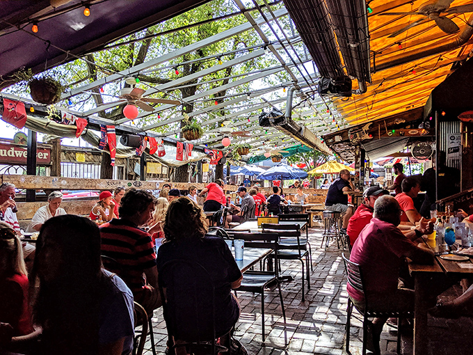 The covered patio creates a festive atmosphere where food, drinks, and conversation flow as naturally as the Mississippi River nearby.