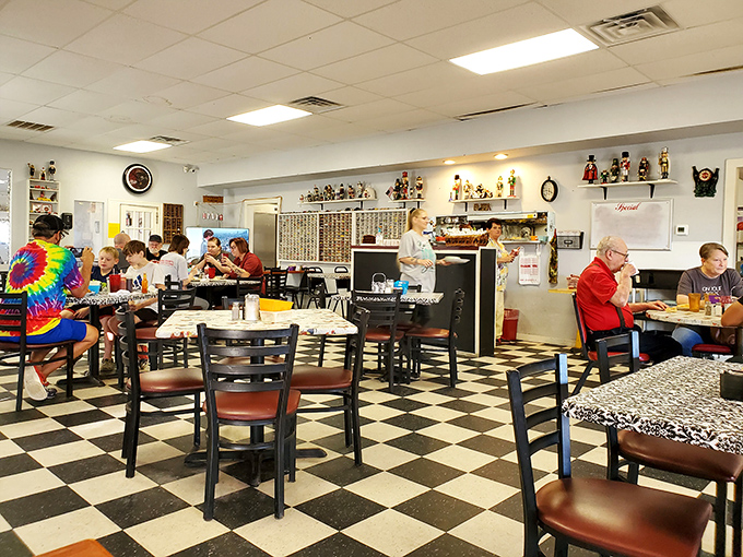 The black and white checkered floor says "classic diner," but the bustling crowd of locals says "you've found the real deal."