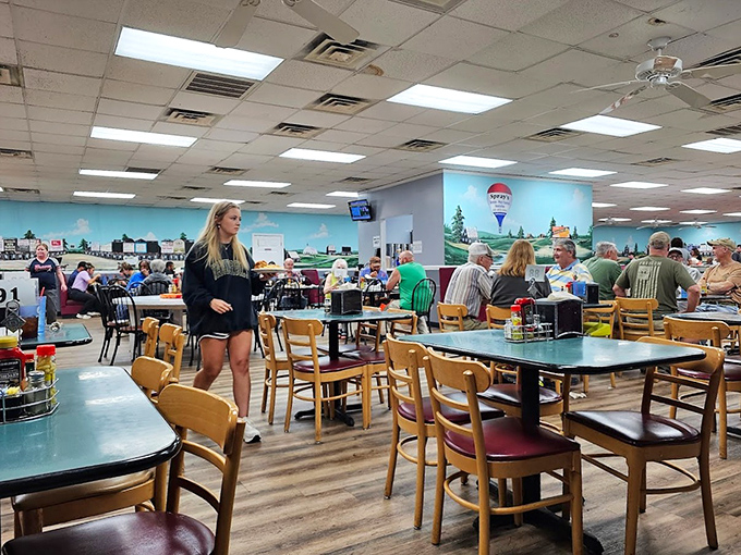 The dining room hums with the sound of satisfied customers. Notice the mural &ndash; local scenery that reminds you exactly where these flavors come from.