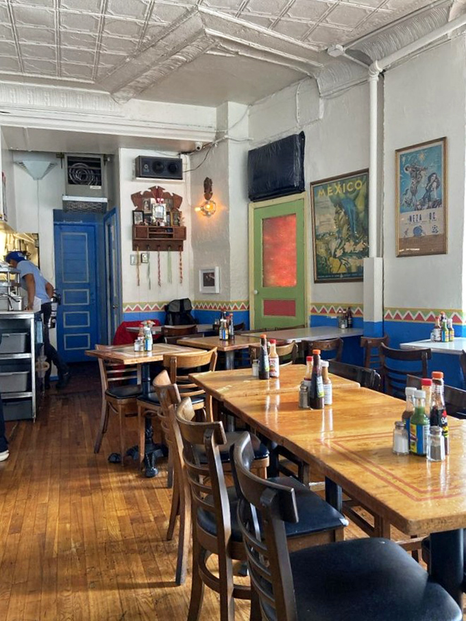 Coffee with a friend at Lupe's blue tables &ndash; where caffeine meets conversation against a backdrop of New York hustle and authentic Mexican charm.