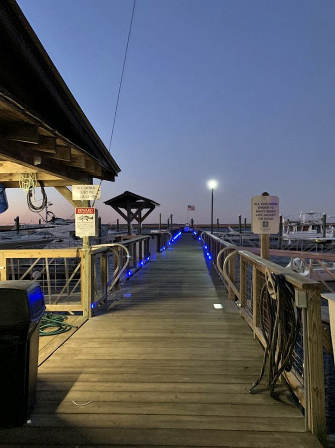 Blue lights guide you to seafood nirvana. This dock isn't just functional&mdash;it's the yellow brick road to coastal cuisine paradise.