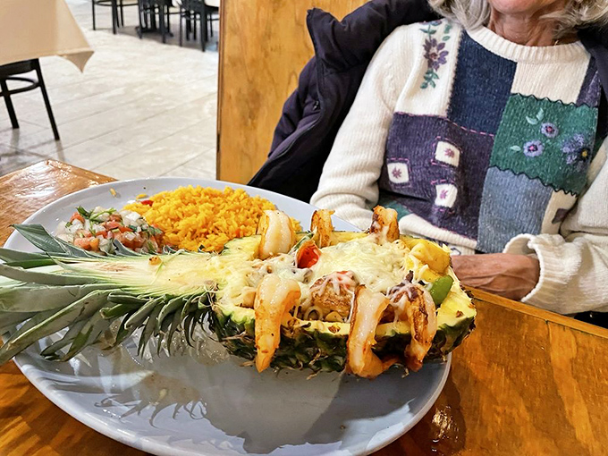 The pineapple isn't just a serving vessel&mdash;it's nature's way of saying, "This seafood dish deserves dramatic presentation." And I fully agree.