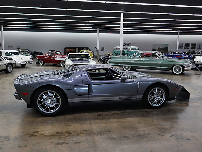 This vintage roadster sits against a backdrop of nostalgic Americana, reminding us that cars weren't just transportation but rolling art.