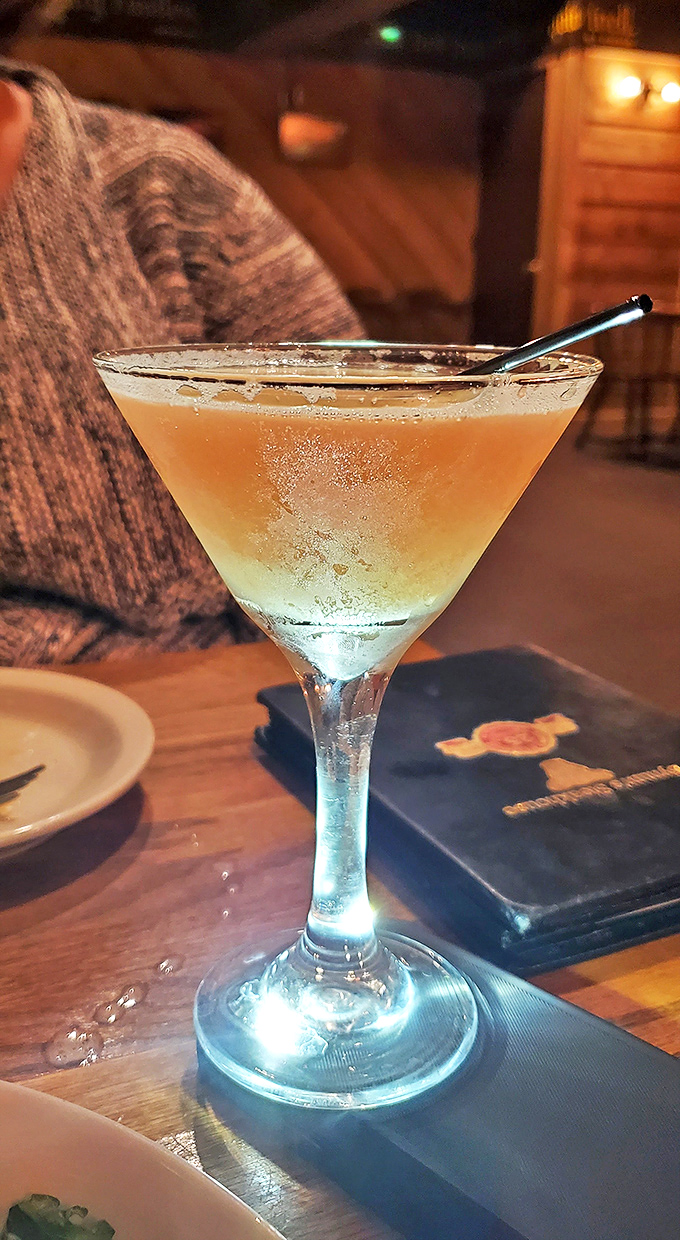 A well-crafted martini catching the light just right&mdash;liquid courage before making the important decision: ribeye or strip?