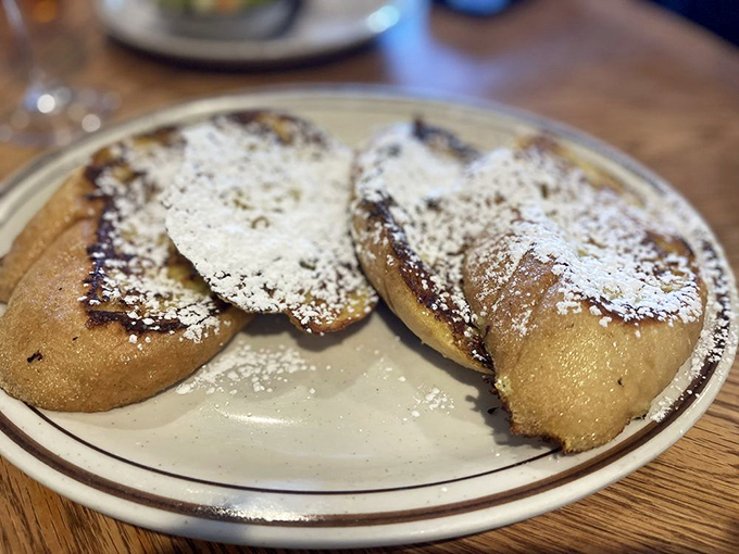 French toast that puts France on notice. Dusted with powdered sugar like fresh snow on delicious mountains of breakfast bliss.