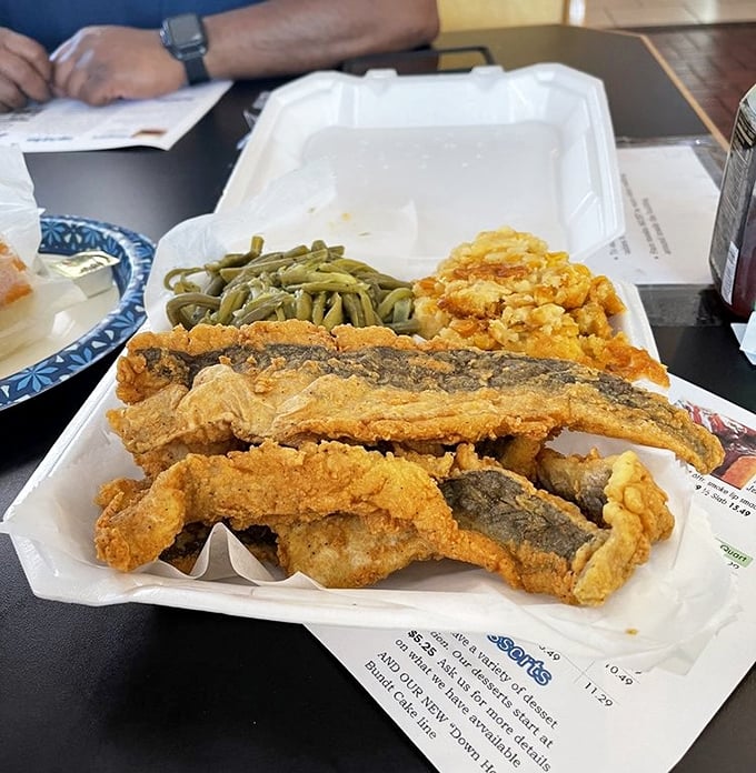 Fried fish that's wearing its golden jacket with pride. Those green beans and mac and cheese make excellent supporting actors.
