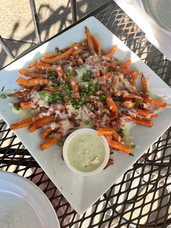 Loaded sweet potato fries with a side of creamy dipping sauce&mdash;proof that side dishes deserve their moment in the spotlight too.