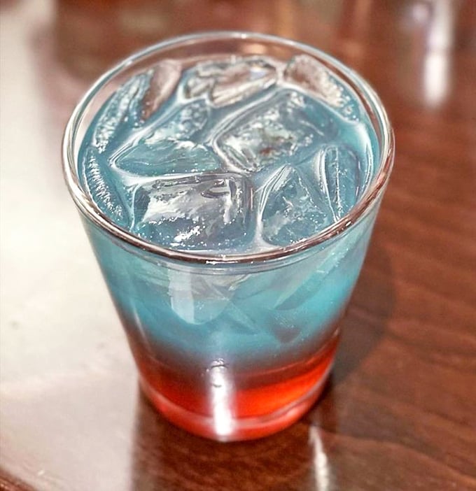 The Harlem Blues cocktail performs a delightful magic trick &ndash; layered colors that promise a refreshing interlude between soul food favorites.
