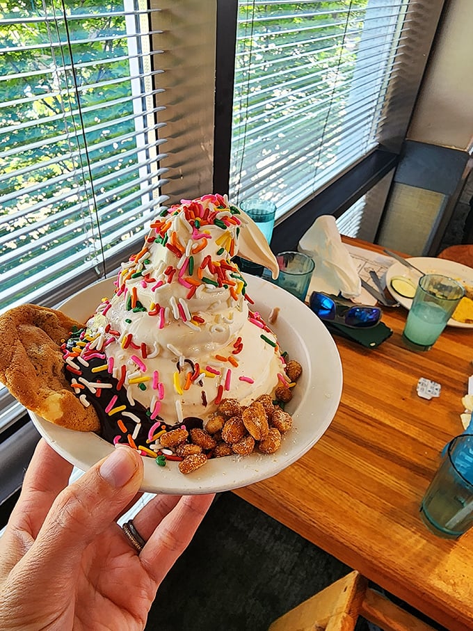 Ice cream sundae architecture at its finest&mdash;a mountain of soft-serve crowned with rainbow sprinkles and surrounded by crunchy bits of happiness.