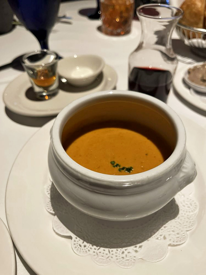 This isn't just soup; it's liquid luxury in a bowl. The lobster bisque glows with promise, like a sunset you can eat with a spoon.