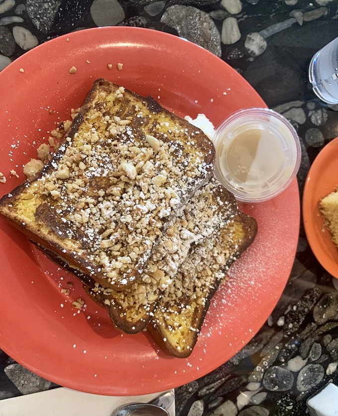French toast that's had a glow-up, dusted with powdered sugar and nuts. Breakfast or dessert? The line blurs deliciously.
