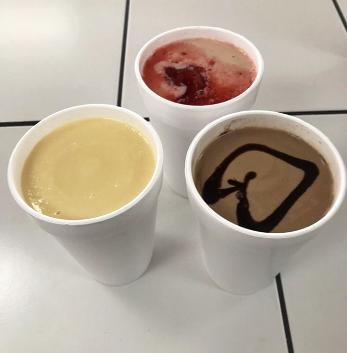 The milkshake trifecta: chocolate, vanilla, and strawberry standing at attention like sweet, creamy soldiers ready for duty.