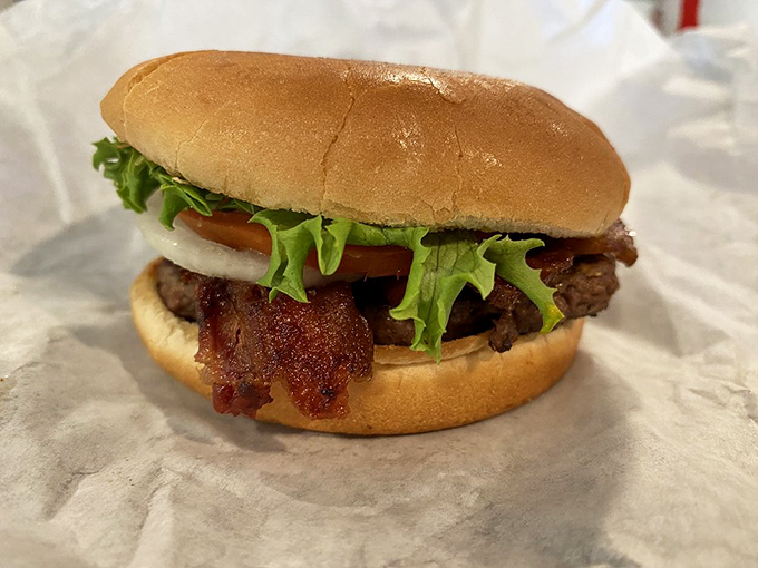 Size isn't everything—this mini bacon burger packs all the flavor of its bigger siblings into a perfectly proportioned package. Burger artistry at its finest.