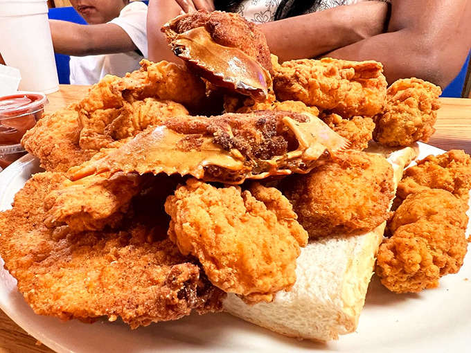 When fried seafood is stacked this high, you don't need fancy china. Paper plates just mean more budget went toward what matters.