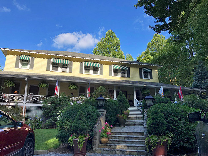 The Orchard Inn stands as a yellow-painted testament to Southern hospitality, where rocking chair diplomacy is still practiced daily on that inviting porch.