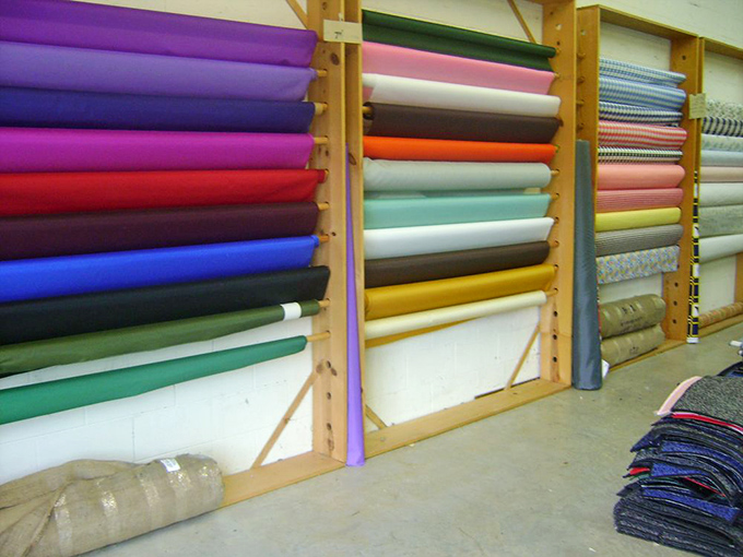 Solid-colored fabrics line up like obedient soldiers, each roll patiently waiting to become the supporting actor in your next quilting blockbuster.
