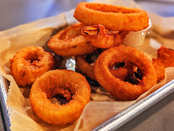 These aren't just onion rings; they're golden halos of crispy goodness waiting to be dunked in that tangy side sauce.
