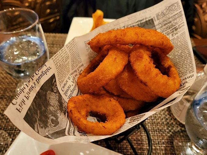 Onion rings served on newspaper &ndash; a humble side elevated to art form. Crispy, golden-brown halos of happiness that disappear all too quickly.