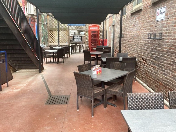 The outdoor patio offers a breath of fresh air with a side of brick-walled charm and that iconic red phone booth nodding to British heritage.