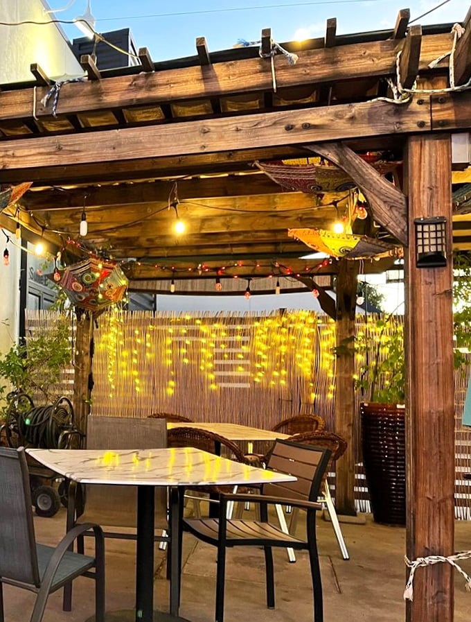 The outdoor pergola creates a magical dining alcove where fairy lights transform evening meals into something from a Bollywood romance.