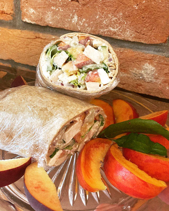 The Peach Wrap in its natural habitat&mdash;surrounded by fresh fruit, looking like the prom queen of the deli counter.