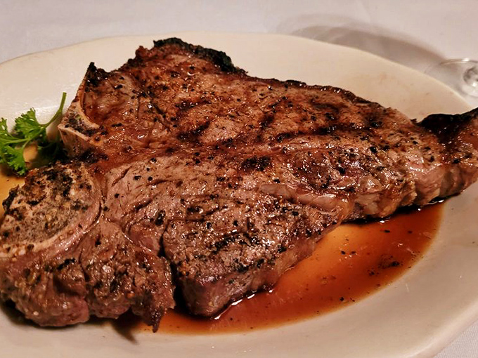 The Porterhouse doesn't just sit on the plate—it commands attention like a Broadway star taking center stage for the final act.