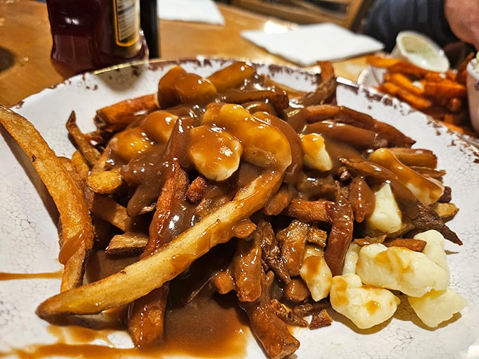 Poutine: where french fries, gravy, and cheese curds come together in a dish that makes you wonder why Canada hasn't taken over the world yet.