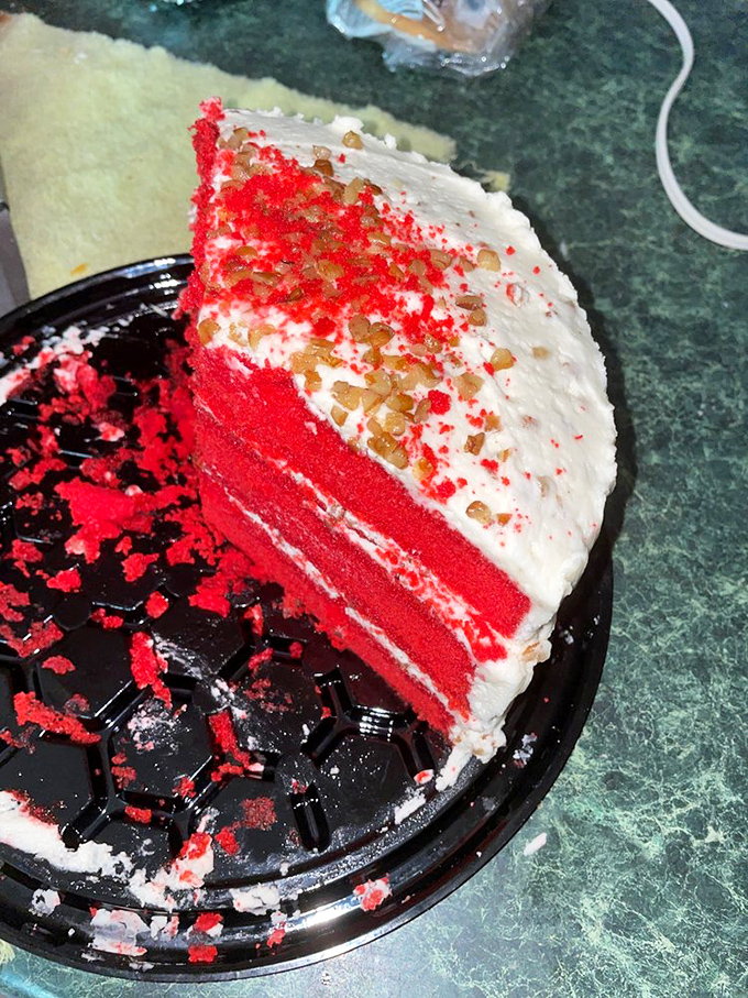 Red velvet cake so vivid it could stop traffic, layered with cream cheese frosting that would make angels weep with joy.