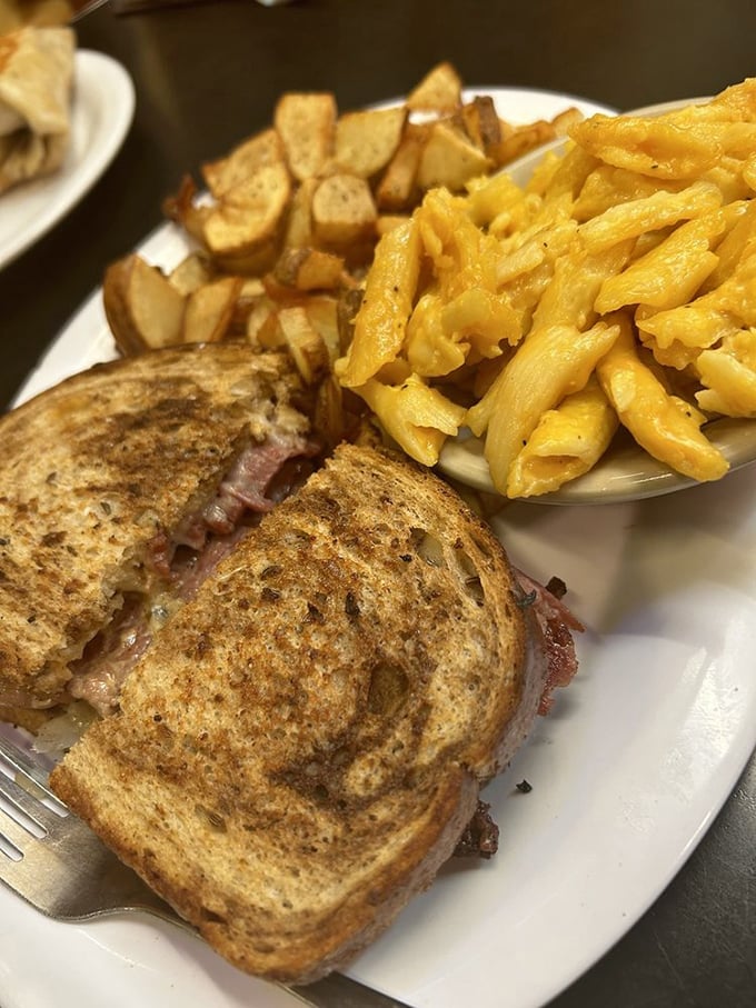The Reuben sandwich and home fries—a dynamic duo that's changed more lives than self-help books. That toasty marble rye deserves its own monument.
