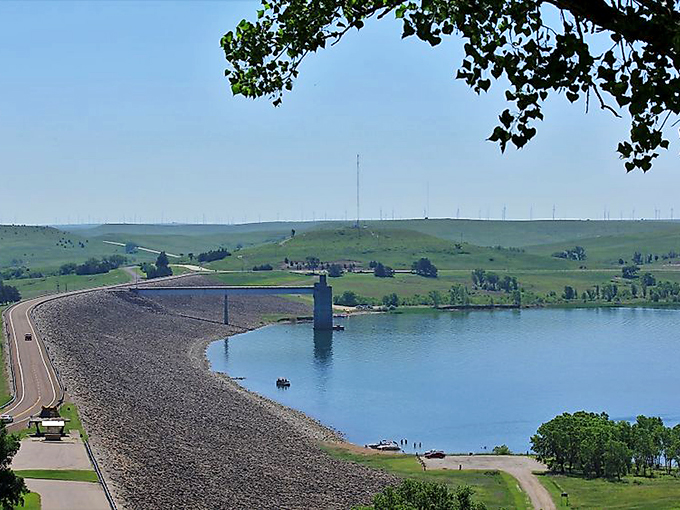 Wilson Lake stretches blue and inviting beneath the Kansas sky, proving that "flat" is the most misleading word ever used to describe this state.