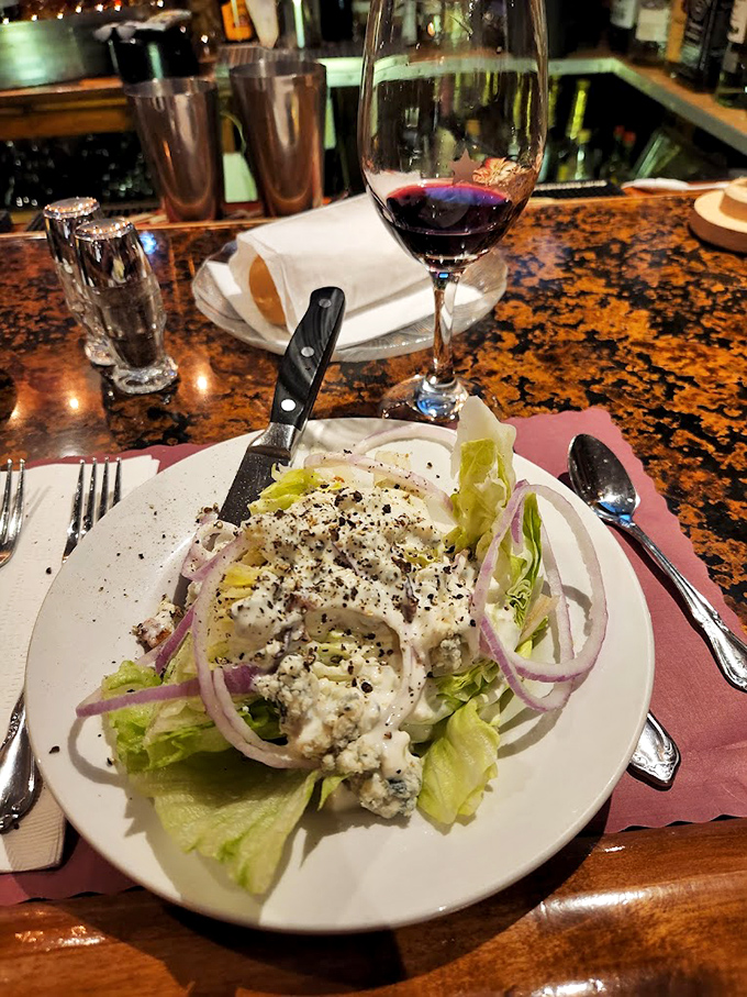A wedge salad that refuses to apologize for its simplicity. Blue cheese, red onions, and the crisp lettuce working in perfect harmony.