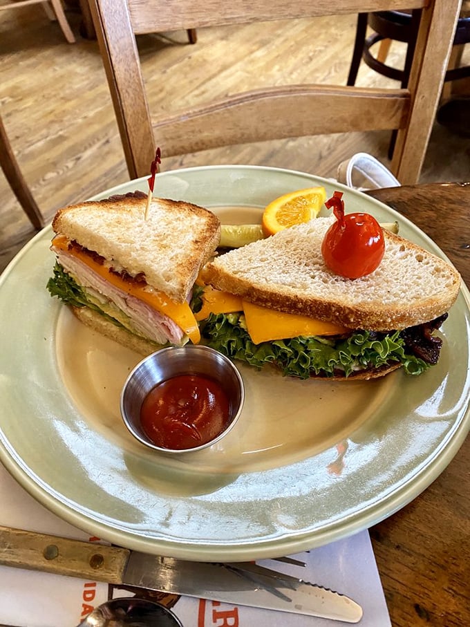 A sandwich so perfectly constructed it could teach architecture classes, complete with the ceremonial cherry tomato hat and ketchup sidekick.