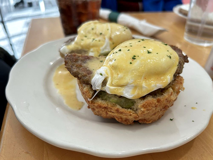 Eggs Benedict gets a Southern makeover with biscuits standing in for English muffins—a diplomatic improvement even the British would approve.
