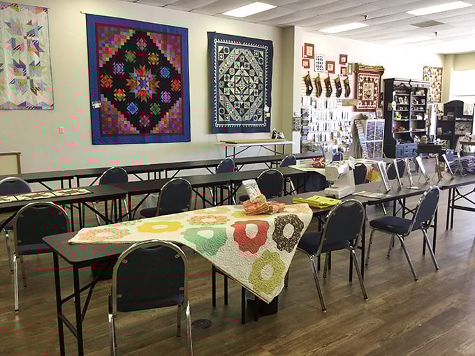 The classroom sanctuary where quilting magic happens&mdash;complete with inspirational wall hangings that silently judge your seam allowances.