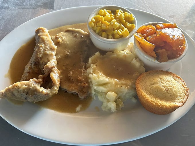 Smothered pork chops swimming in gravy with a side of corn&mdash;proof that heaven exists and it's located on NE 23rd Street.