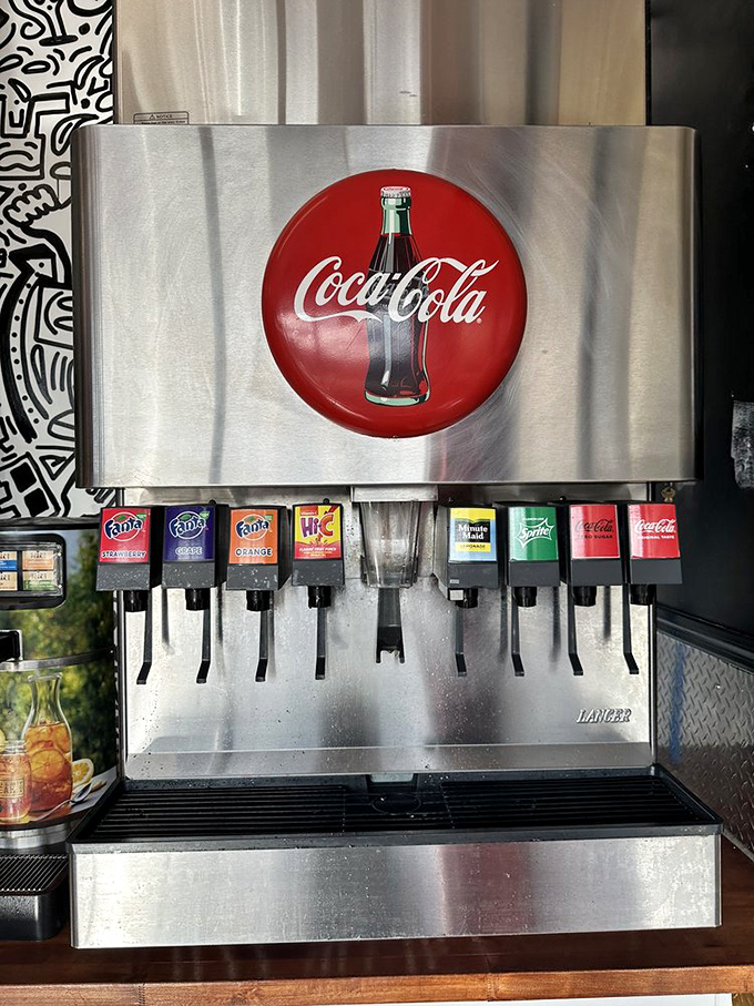 The soda fountain stands ready like an old friend. In the burger universe, the perfect fizzy companion is just as important as the main event.