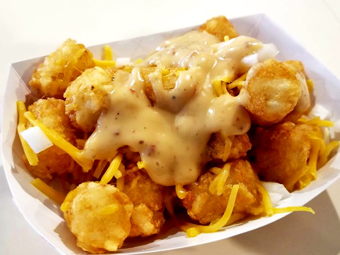 Golden tater tots smothered in cheese sauce. Comfort food that speaks a universal language: "Everything's going to be alright."