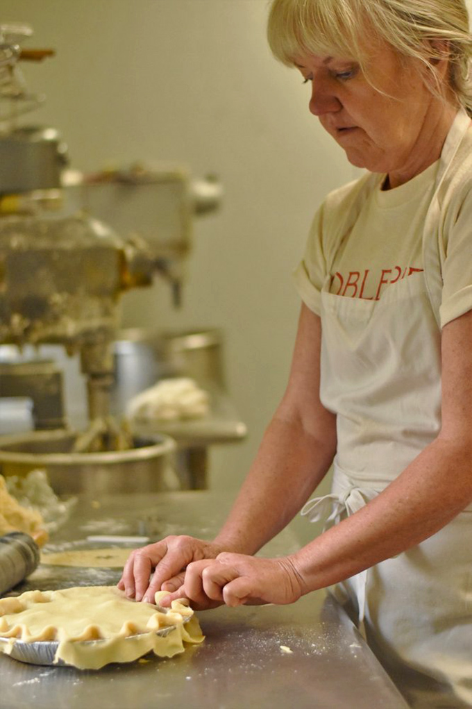 Hands that have mastered the ancient art of pastry crimping, creating edible masterpieces one pie at a time.