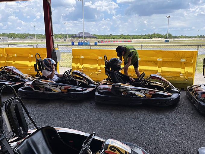 The sacred ritual of kart preparation. Like watching pit crews at Indianapolis, except nobody's career depends on that loose bolt.
