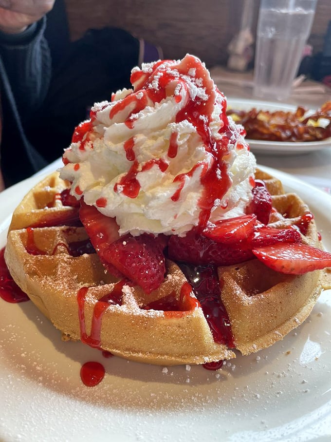This Belgian waffle topped with strawberries and whipped cream isn't breakfast&mdash;it's dessert with permission to eat it before noon.