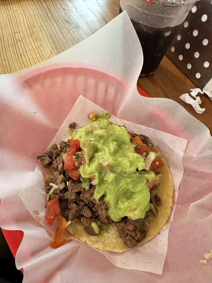That generous dollop of guacamole isn't just a topping &ndash; it's the crown jewel atop a throne of seasoned beef and fresh toppings.
