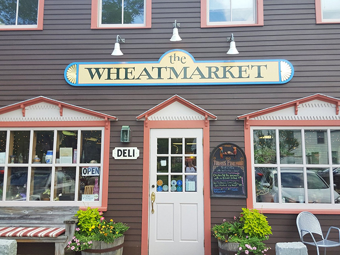 Quaint storefronts and parked cars line this sunny street, offering you a friendly invitation to explore local shops and cafes.