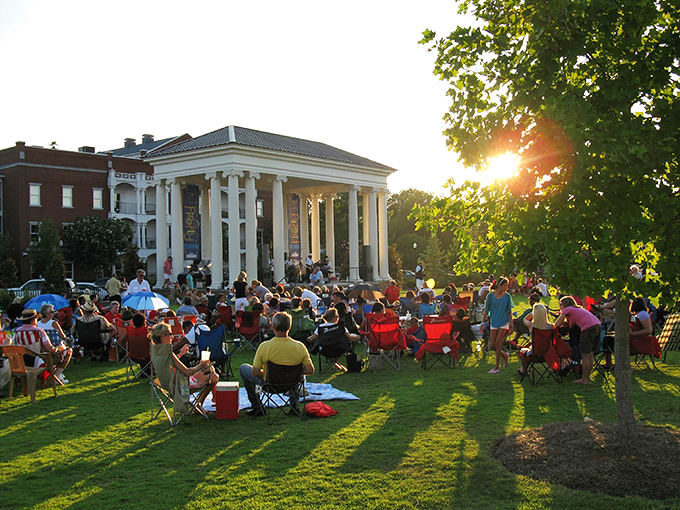 As golden hour bathes the lawn in honey-colored light, locals gather with lawn chairs and picnic baskets for an evening of community connection.