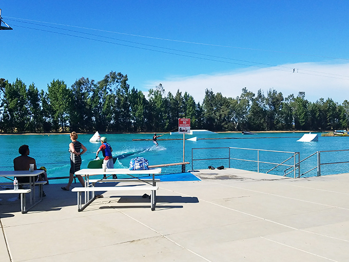 A wakeboarding maestro glides across the rail with the grace of a ballet dancer and the courage of someone with excellent health insurance.