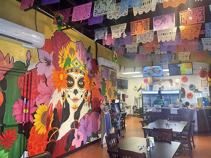 Authentic Mexican ambiance with warm golden walls and festive papel picado creates the perfect backdrop for culinary memories.