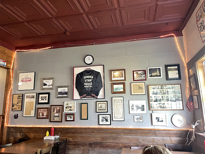 The wall of memories showcases decades of Gunder history, with the restaurant's signature jacket displayed like a championship banner.