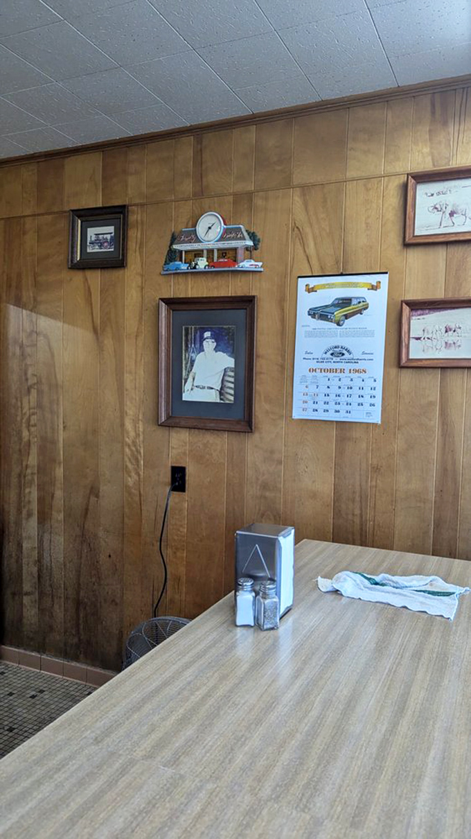 Wood-paneled walls serve as a community scrapbook, documenting decades of memories made over exceptional burgers.