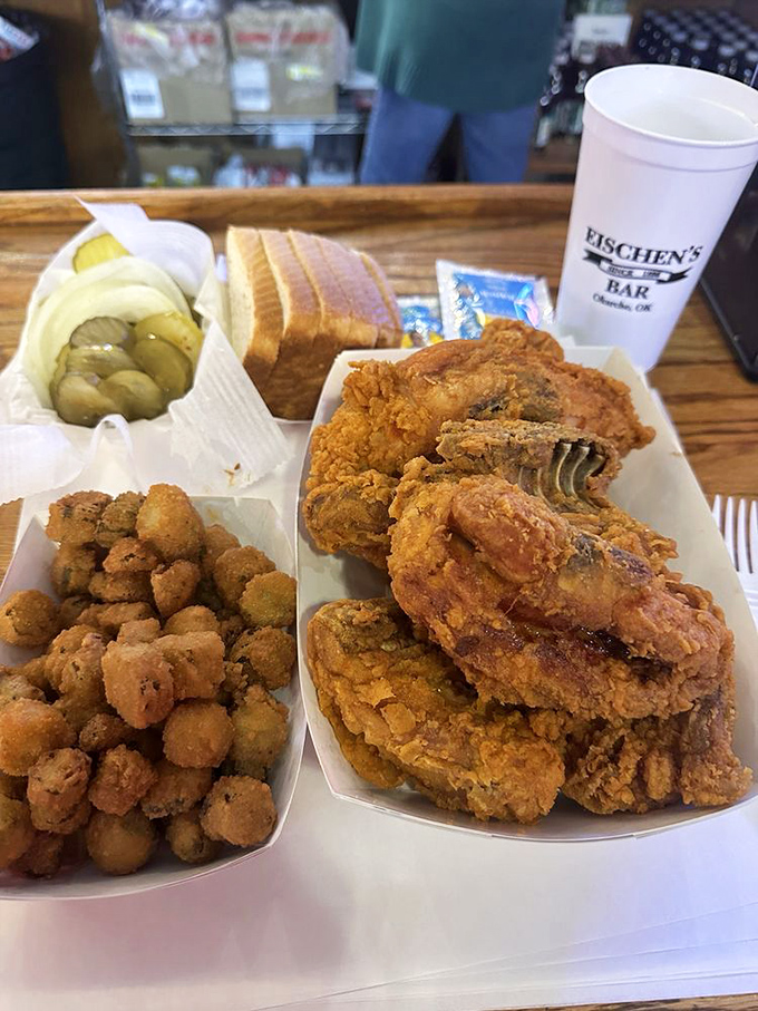 The complete Eischen's experience: golden chicken, crispy okra, tangy pickles, and bread that's ready to soak up every last bit of flavor.
