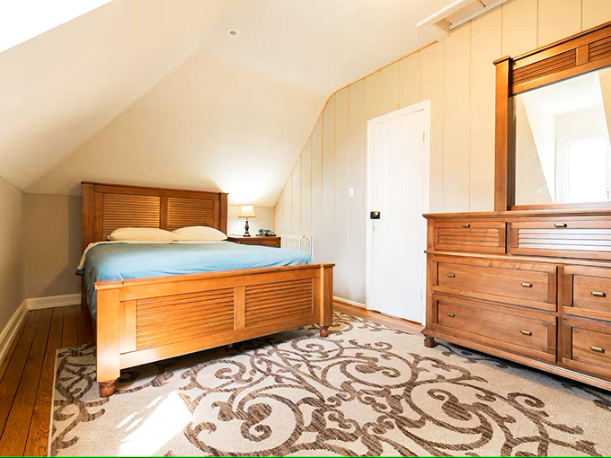 Tucked under sloping eaves, this attic bedroom transforms what could be forgotten space into a charming retreat worthy of a fairy tale.