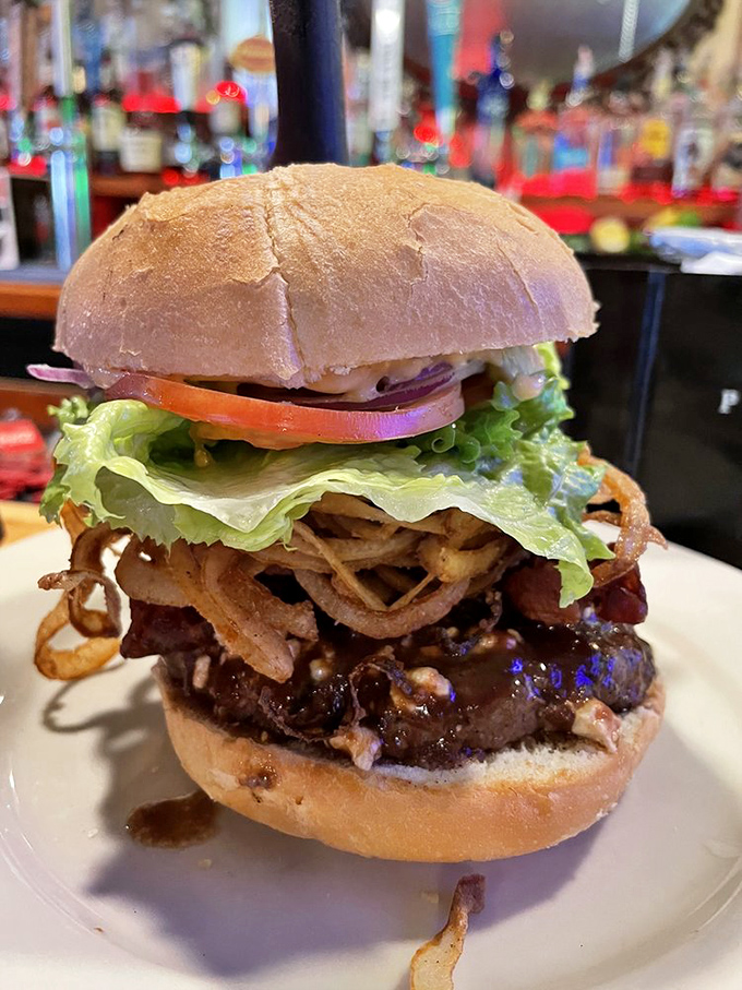 This isn't just a burger&mdash;it's architecture. A towering achievement of beef, crispy onions, and fresh vegetables that demands both hands and your full attention.